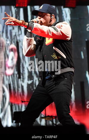 Rapper Logic is shown performing on stage during a live concert ...