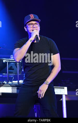 Rapper Logic is shown performing on stage during a live concert ...