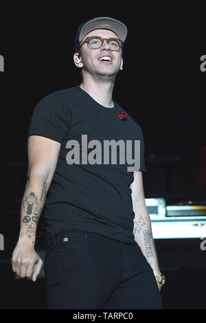 Rapper Logic is shown performing on stage during a live concert ...