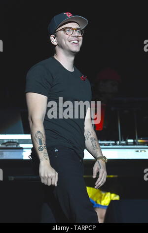 Rapper Logic is shown performing on stage during a live concert ...