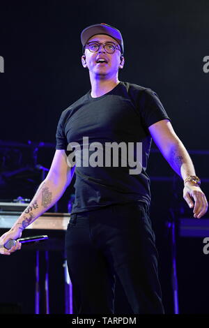 Rapper Logic is shown performing on stage during a live concert ...