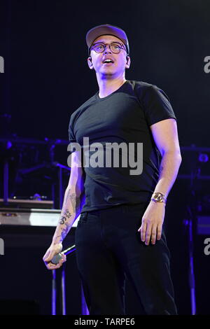 Rapper Logic is shown performing on stage during a live concert ...