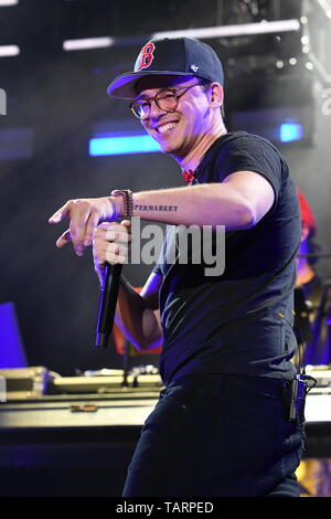 Rapper Logic is shown performing on stage during a live concert ...