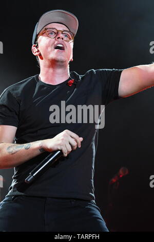 Rapper Logic is shown performing on stage during a live concert ...