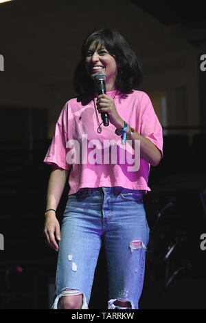 Comedian Melissa Villaseñor is shown performing on stage during a "live ...