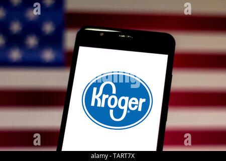In this photo illustration, a Kroger logo is displayed on the screen of ...