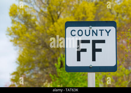 County road sign 'FF' and 'U' with Spring trees in background - taken ...