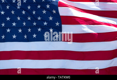 Extreme close up of an unfurled United States flag with blue skies in ...