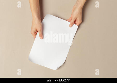 Hand holding papers a4 size Stock Photo - Alamy