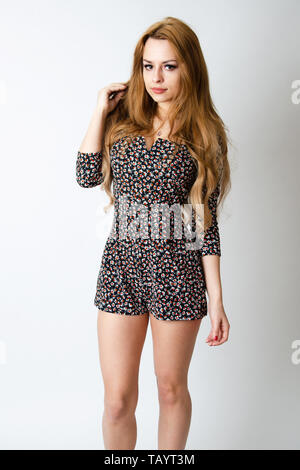 Model in good shape stands on steps and poses on camera. She shows her ...