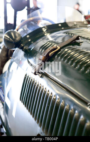 Old worn leather classic car bonnet straps Stock Photo - Alamy