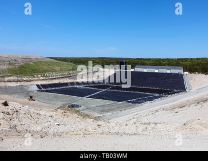 New waste disposal cell being built at landfill with big hole excavated ...