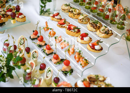 buffet table, Canape, sandwiches, snacks holiday table sliced glasses ...