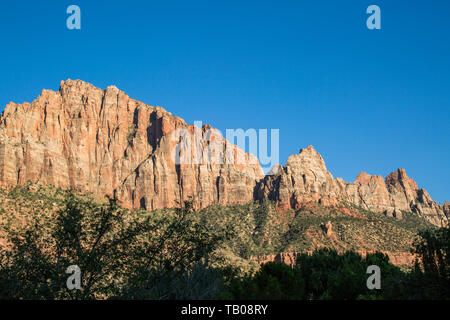 The Watchmen, red rock formations with blue sky in Zion National Park ...