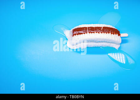 side view melted chocolate flavor popsicle on blue background Stock ...