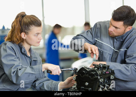 two mechanics operating wheel equilibrium control machinery Stock Photo ...