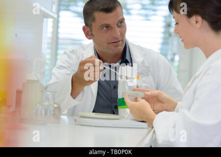 Chinese young man working at pharmacy drugstore thinking looking tired ...