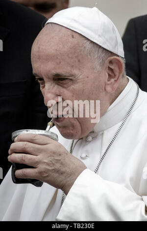 Pope Francis drinks a cup of mate as he leaves at the end of his Weekly ...