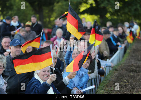 Hoppegarten, Germany, people wave national flags on the day of German ...