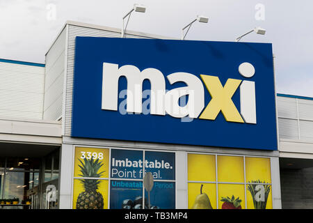 A logo sign outside of a Maxi retail grocery store location in ...