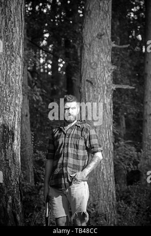 brutal bearded man lumberjack hold axe outdoor. bearded man lumberjack ...