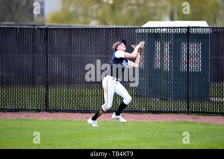 High school outfielder making a running catch to retire a hitter during ...