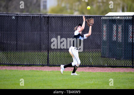 High school outfielder making a running catch to retire a hitter during ...