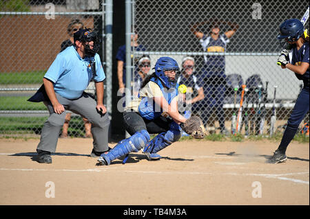 Play at the plate in a high school softball game Stock Photo - Alamy