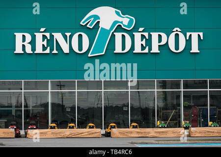 A logo sign outside of a Reno-Depot retail store location in Vaudreuil ...