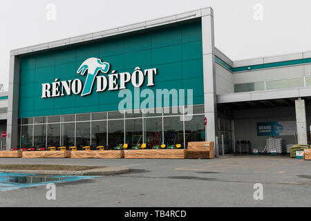 A logo sign outside of a Reno-Depot retail store location in Vaudreuil ...