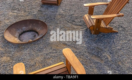 Brown chairs on wooden frame in a casual space Stock Photo - Alamy