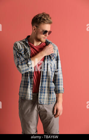 Fashionable young man on color background Stock Photo - Alamy