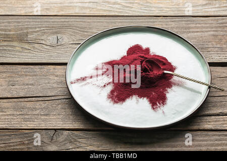 Wooden spoon and plate with acai powder on white background Stock Photo ...