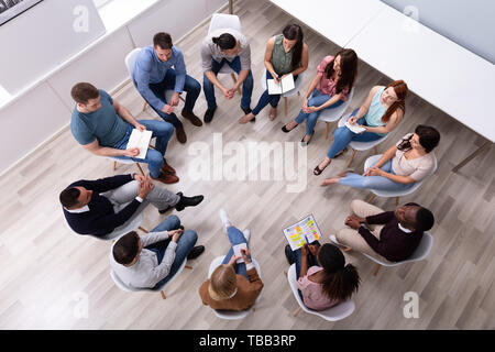 Overhead view of woman talking with diary using smart phone while ...