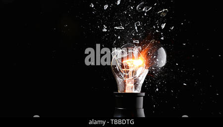 Breaking of light bulb on dark background Stock Photo - Alamy