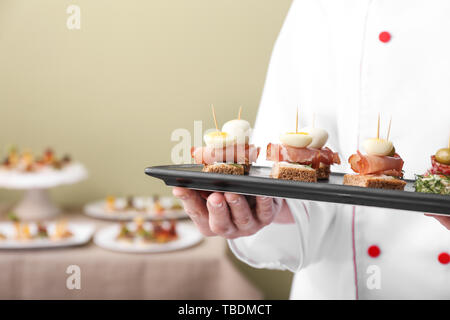Chef holding plate with tasty canapes, closeup Stock Photo - Alamy