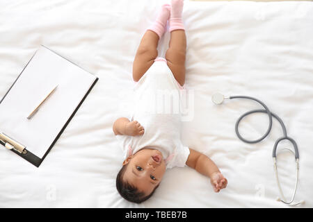 Boy lying on examination table, doctor feeling abdomen Stock Photo ...