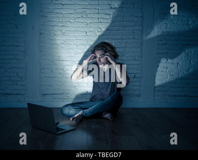 Severely distraught young teen man with laptop suffering cyberbullying ...