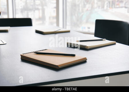 Table with stationery prepared for business meeting in conference hall ...