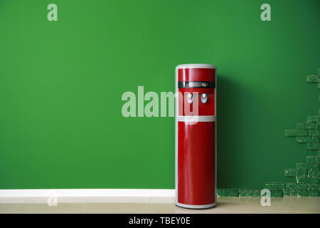 Modern water cooler near color wall Stock Photo - Alamy