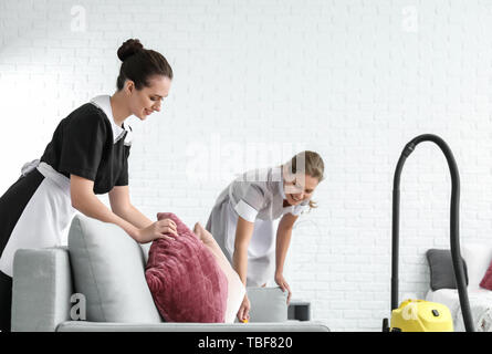 Beautiful female housekeepers working in room Stock Photo - Alamy