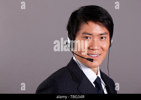 Asian man operator customer service pointing with fingers to different ...