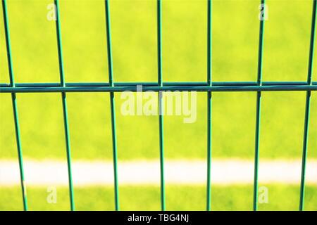 Fencing football field of metal mesh Stock Photo - Alamy