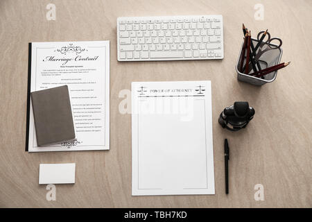 Marriage contract, computer keyboard and stamp on table of notary ...