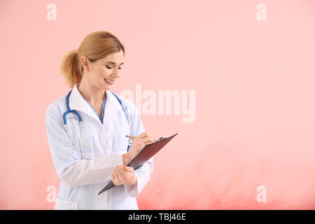 Portrait of beautiful gynecologist on color background Stock Photo - Alamy