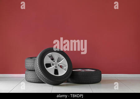 Car tires near color wall Stock Photo - Alamy