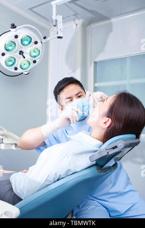 Doctors treat teeth with patients in clinic Stock Photo - Alamy
