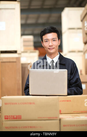 Logistics personnel load and unload cargo at the warehouse Stock Photo ...