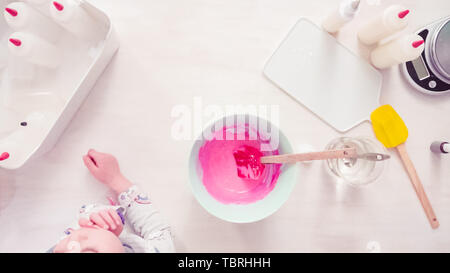 Flat lay. Step by step. Mixing royal icing to decorate sugar cookies ...