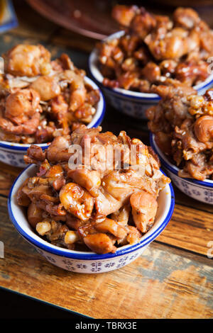Charcoal fire frog pot field chicken meal Stock Photo - Alamy